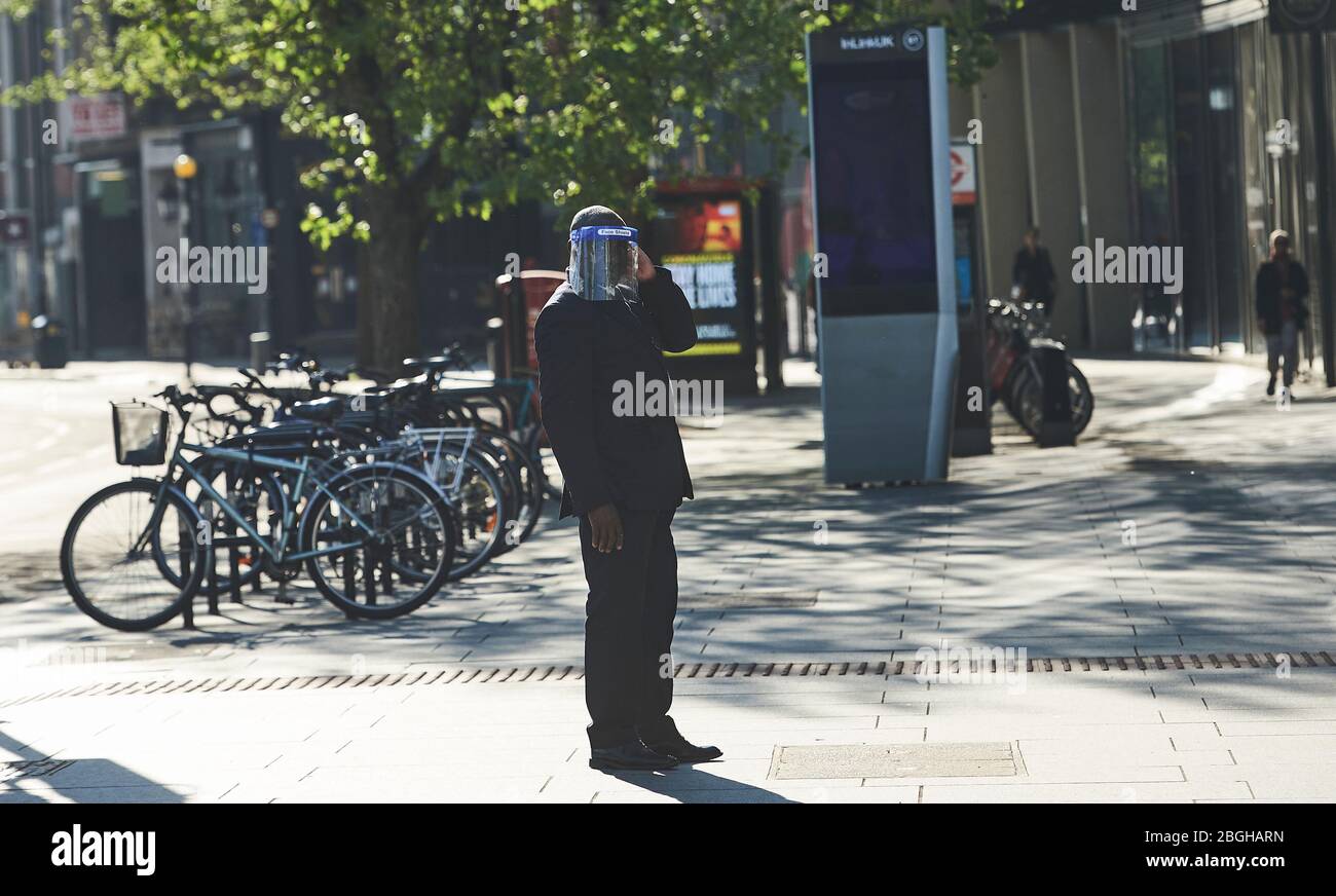 London, UK. 21st April 2020. A Security Guard in a full face mask ...