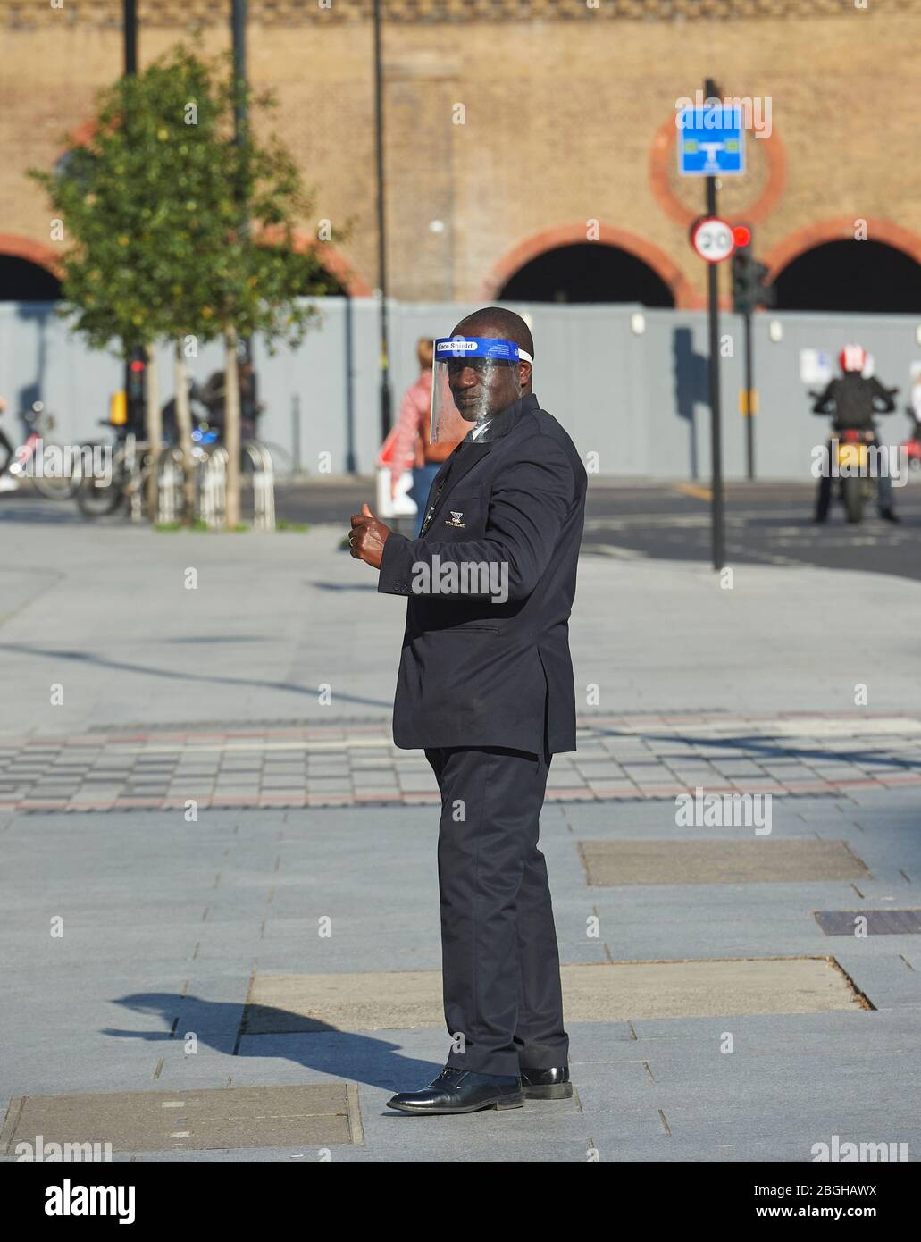 London, UK. 21st April 2020. A Security Guard in a full face mask ...