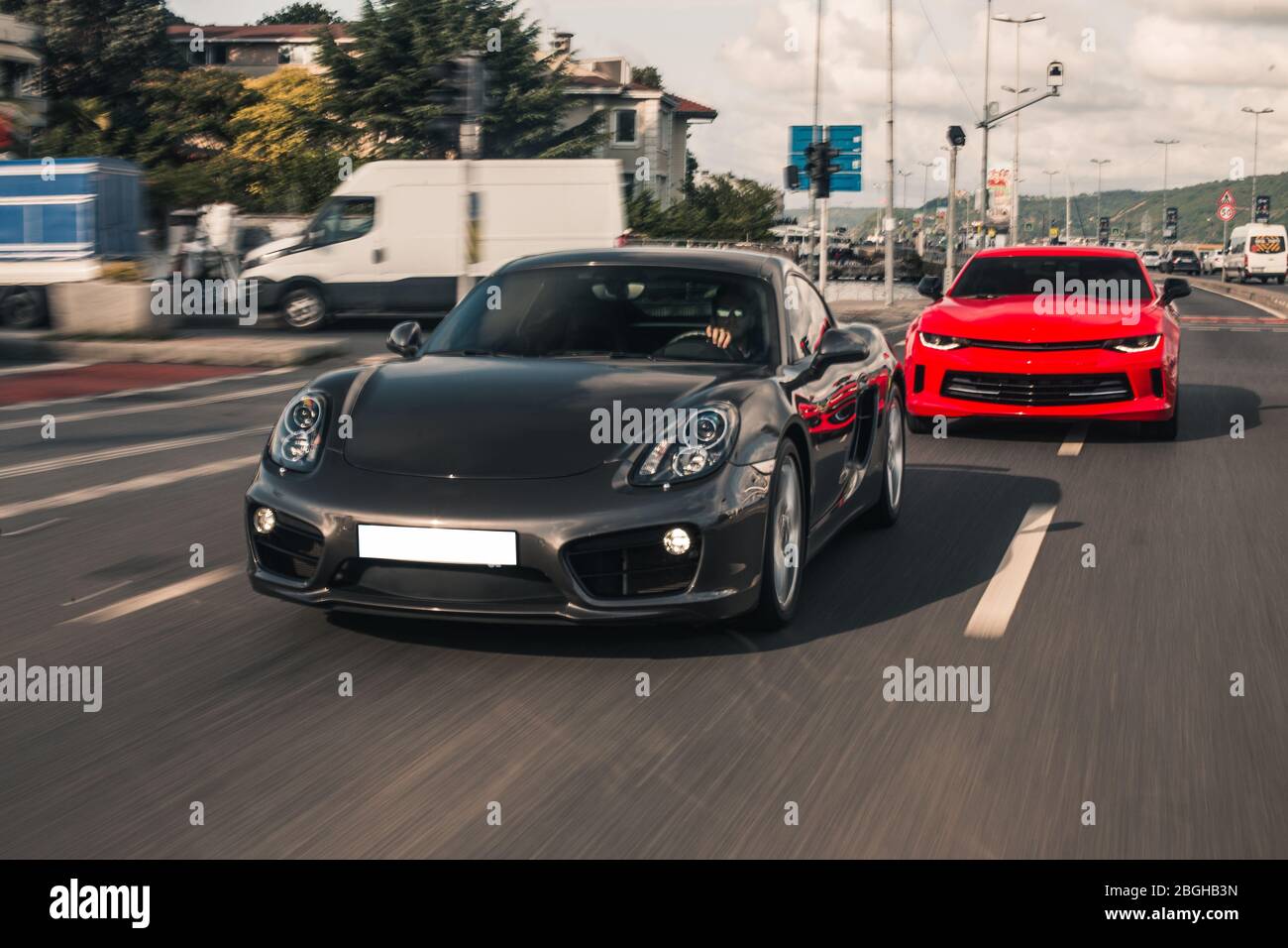 Red and black supercars racing on the city streets Stock Photo - Alamy