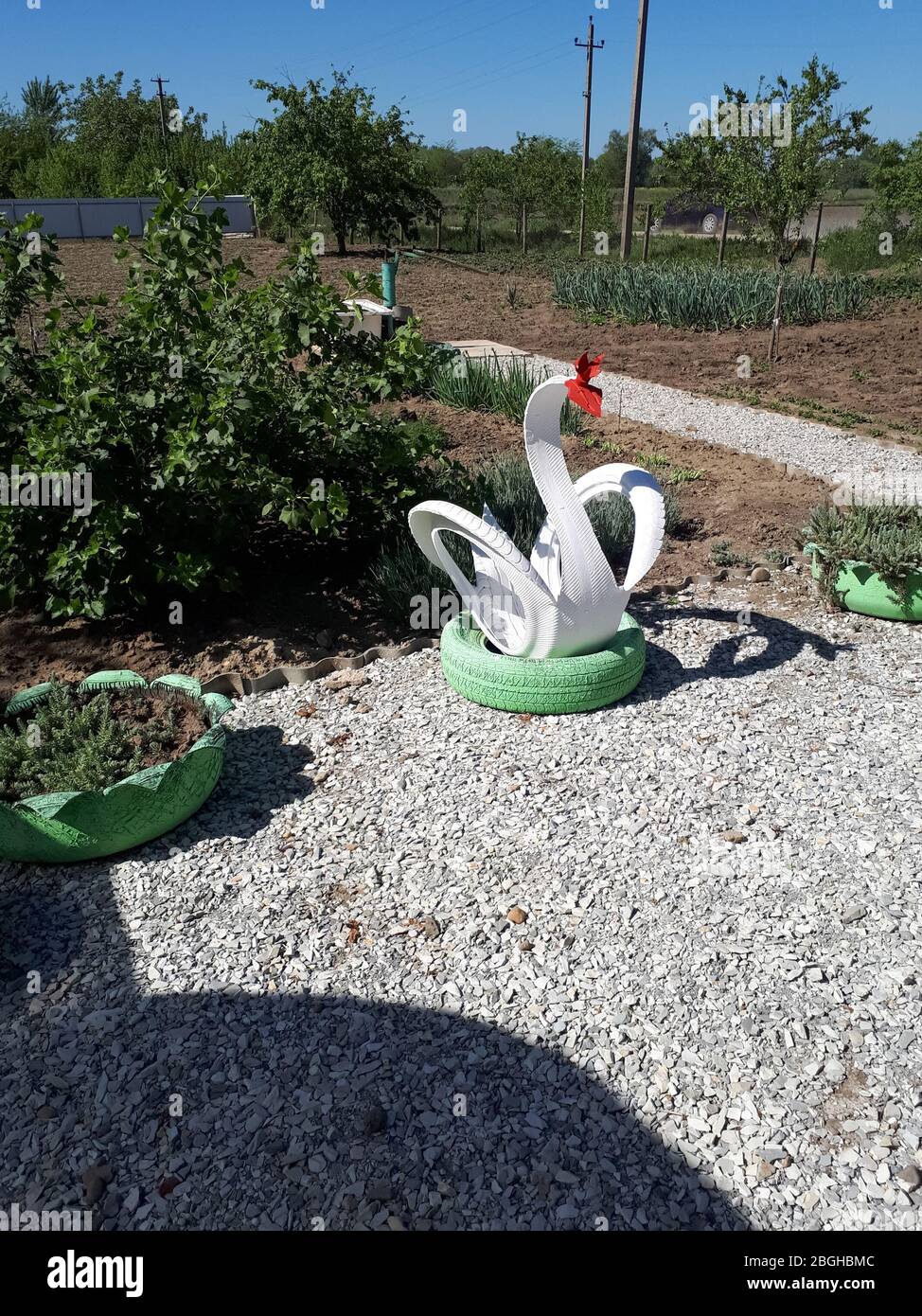 Craft from a rubber tire - a white swan. Decorations in the garden ...