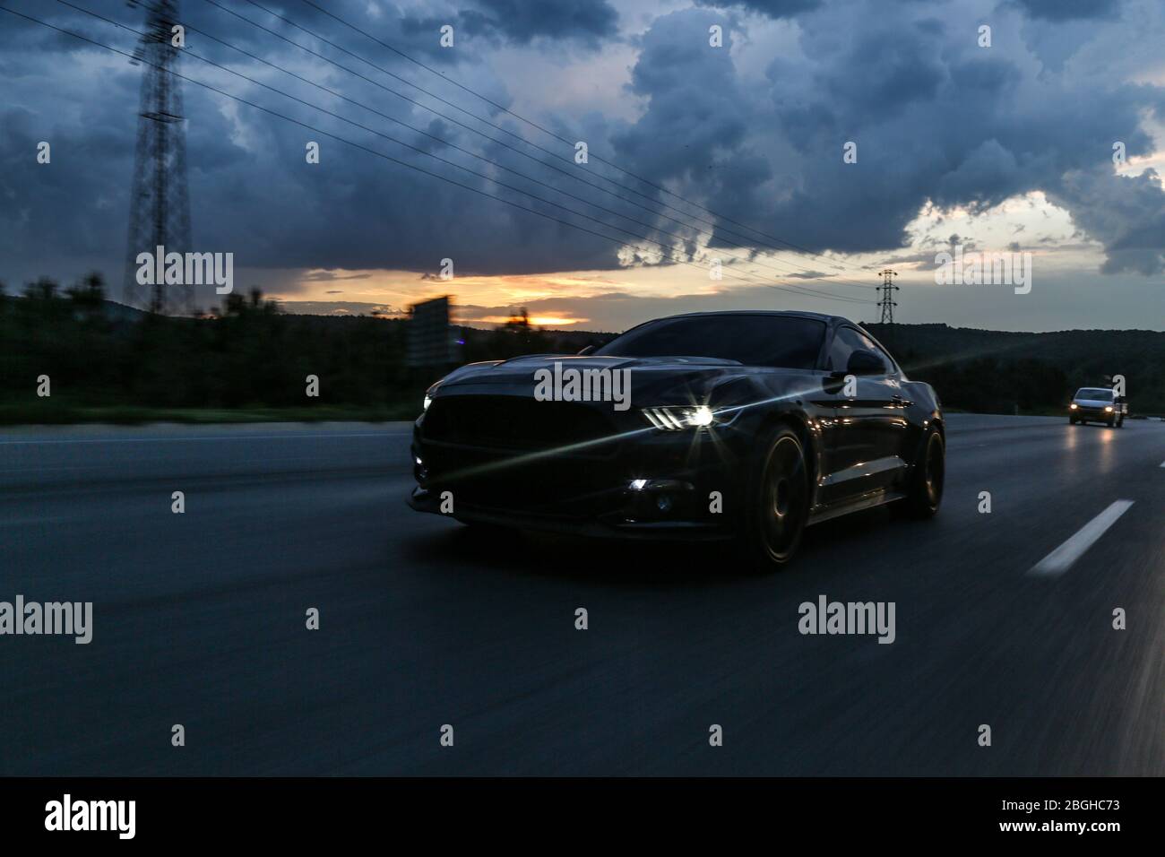 Black turbo motor sport car on the highlands in the darkness Stock ...