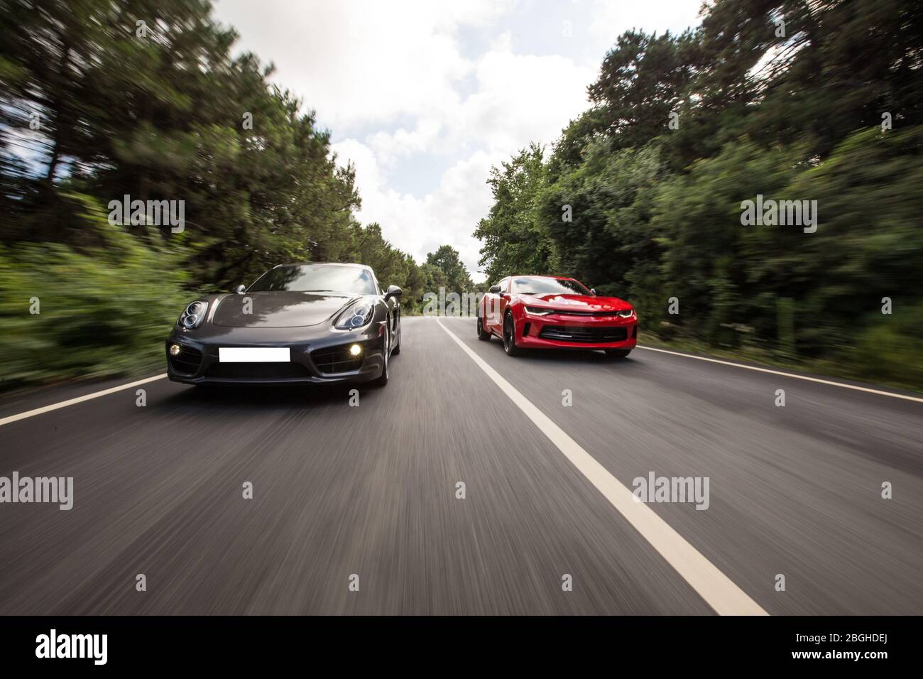 Silver and red sport cars rushing in parallel lines Stock Photo - Alamy