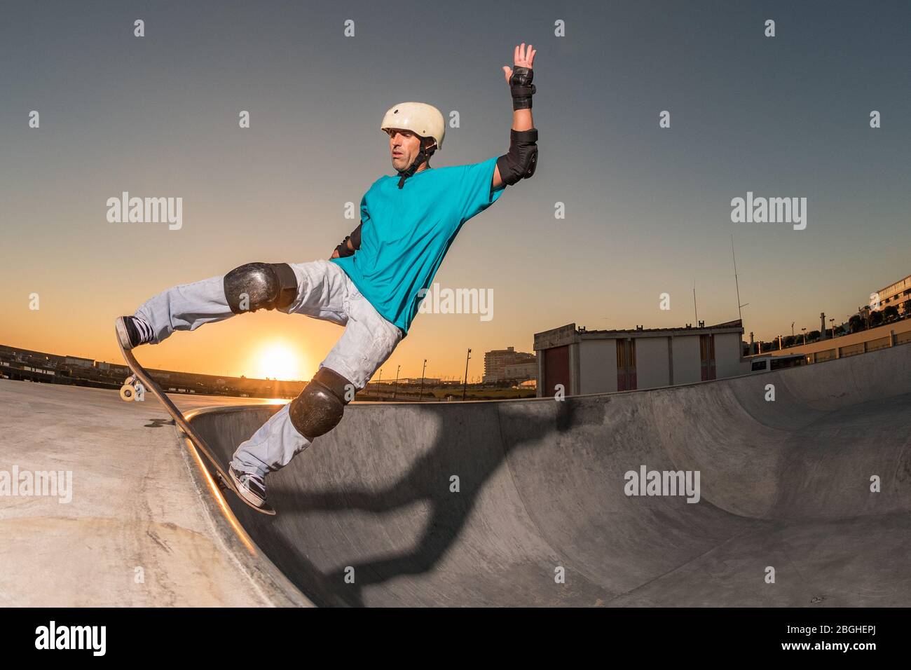 Skateboarder in a concrete pool at skatepark on a beatiful sunset Stock ...