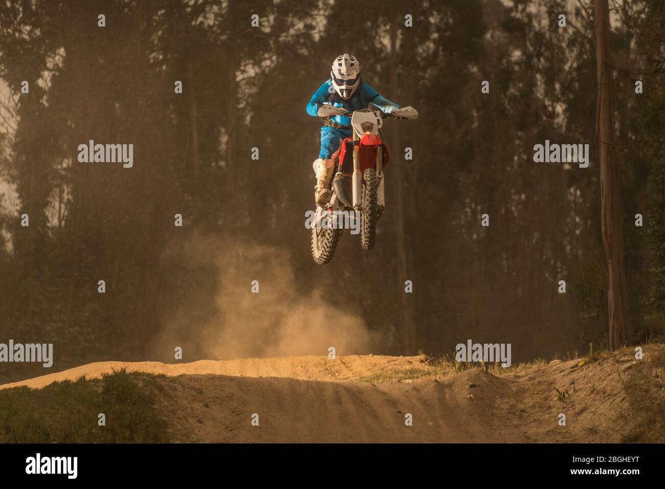Enduro bike rider in action. Jump on sandy terrain Stock Photo - Alamy