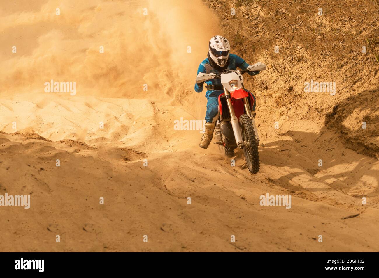 Enduro bike rider on action. Turn on sand terrain Stock Photo - Alamy