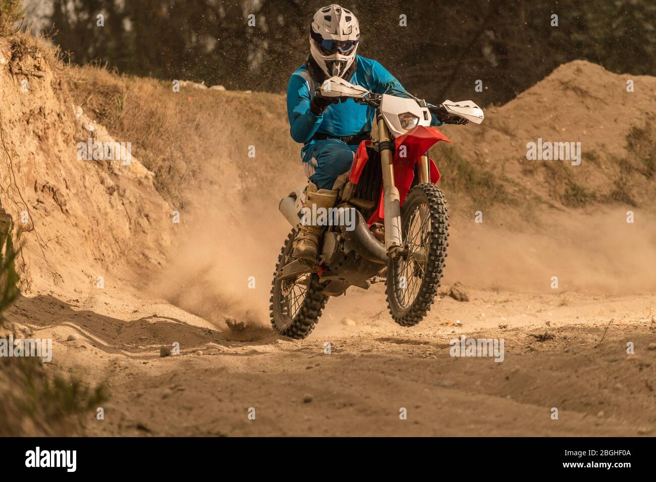 Enduro bike rider on action. Turn on sand terrain Stock Photo - Alamy