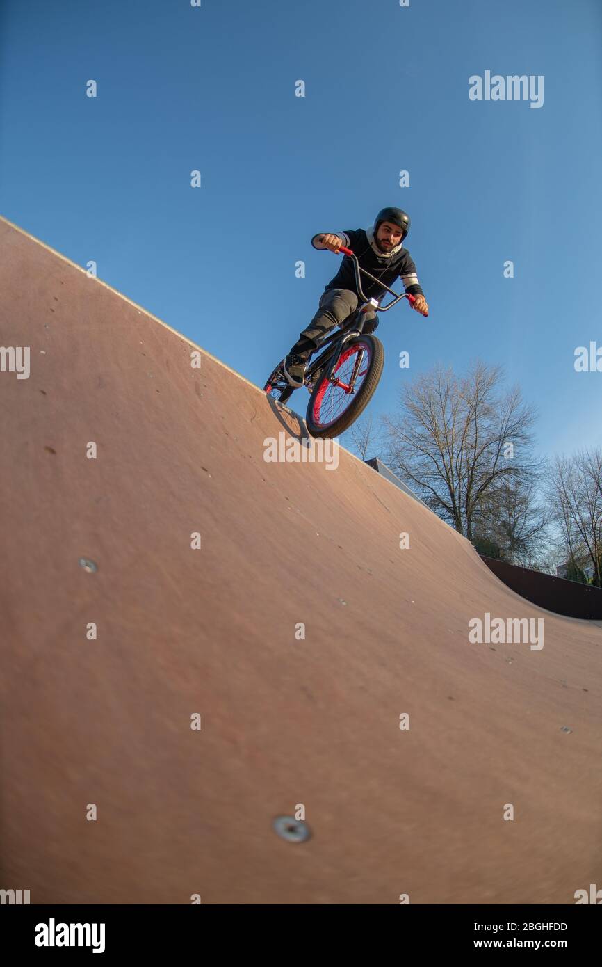 BMX trick in a wooden ramp at skate park Stock Photo - Alamy