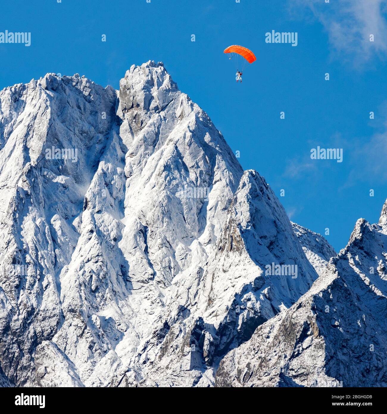 parachutist flying over snowy alps Stock Photo - Alamy