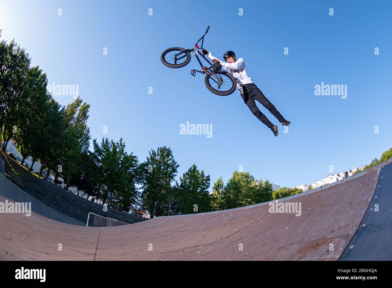 Biker jump high from jump box ramp performing dangerous superman trick ...