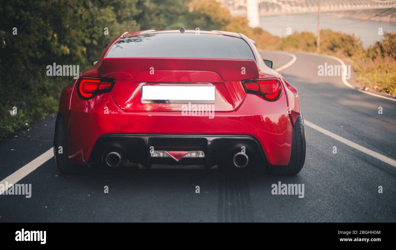 Modern red racing car commercial with panoramic view on the hill Stock ...