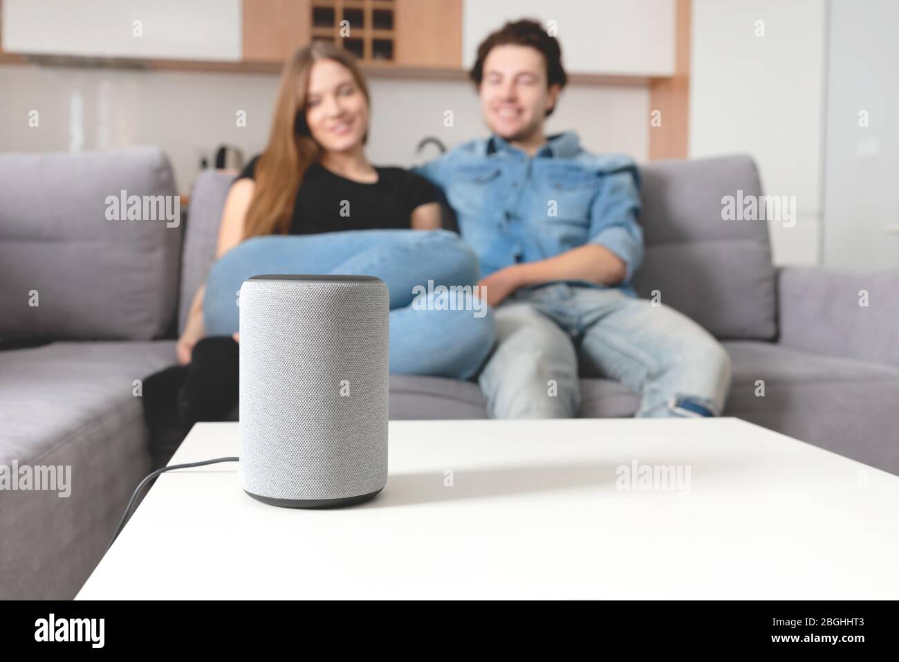 Couple talking command to smart speaker. Intelligent assistant in smart ...