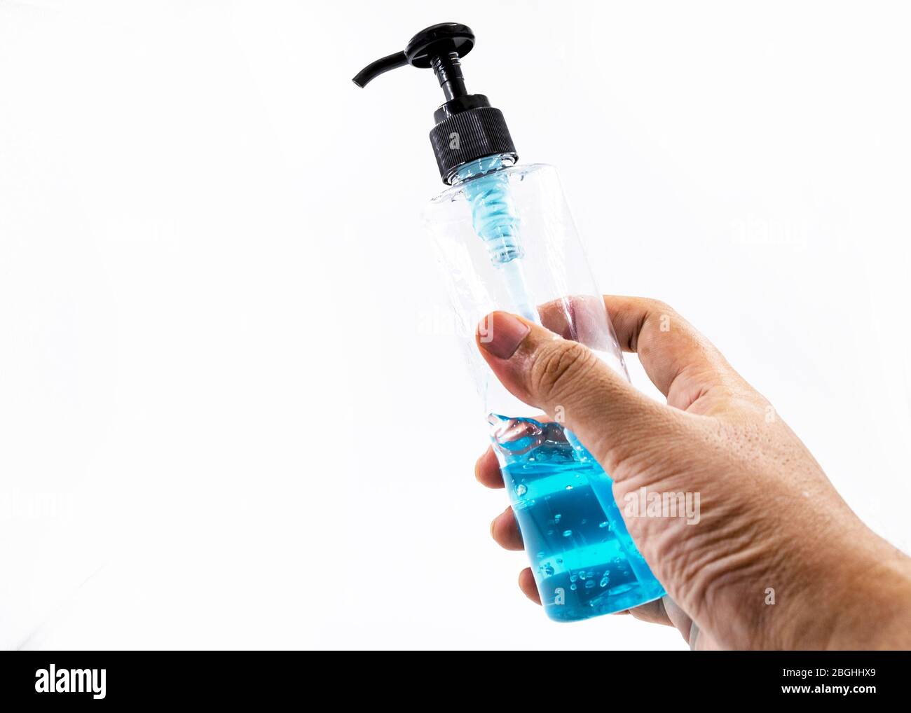Hands using wash hand sanitizer gel pump dispenser on white background ...