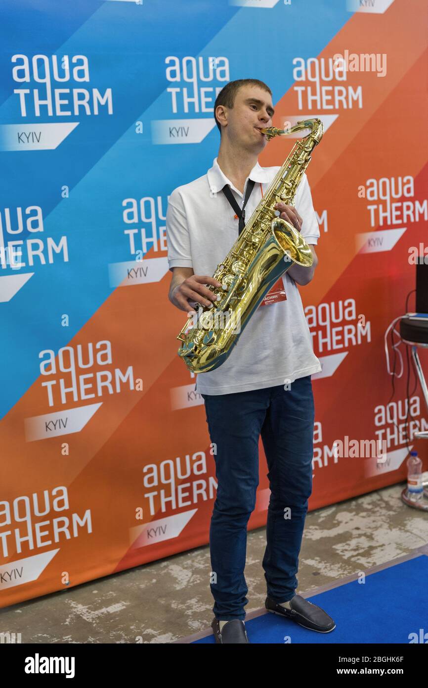 KYIV, UKRAINE - MAY 19,2016: Musician plays the saxophone at Aqua Therm ...