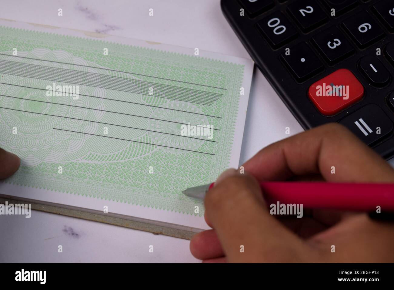 A Businessman writing a check isolated on the table Stock Photo - Alamy