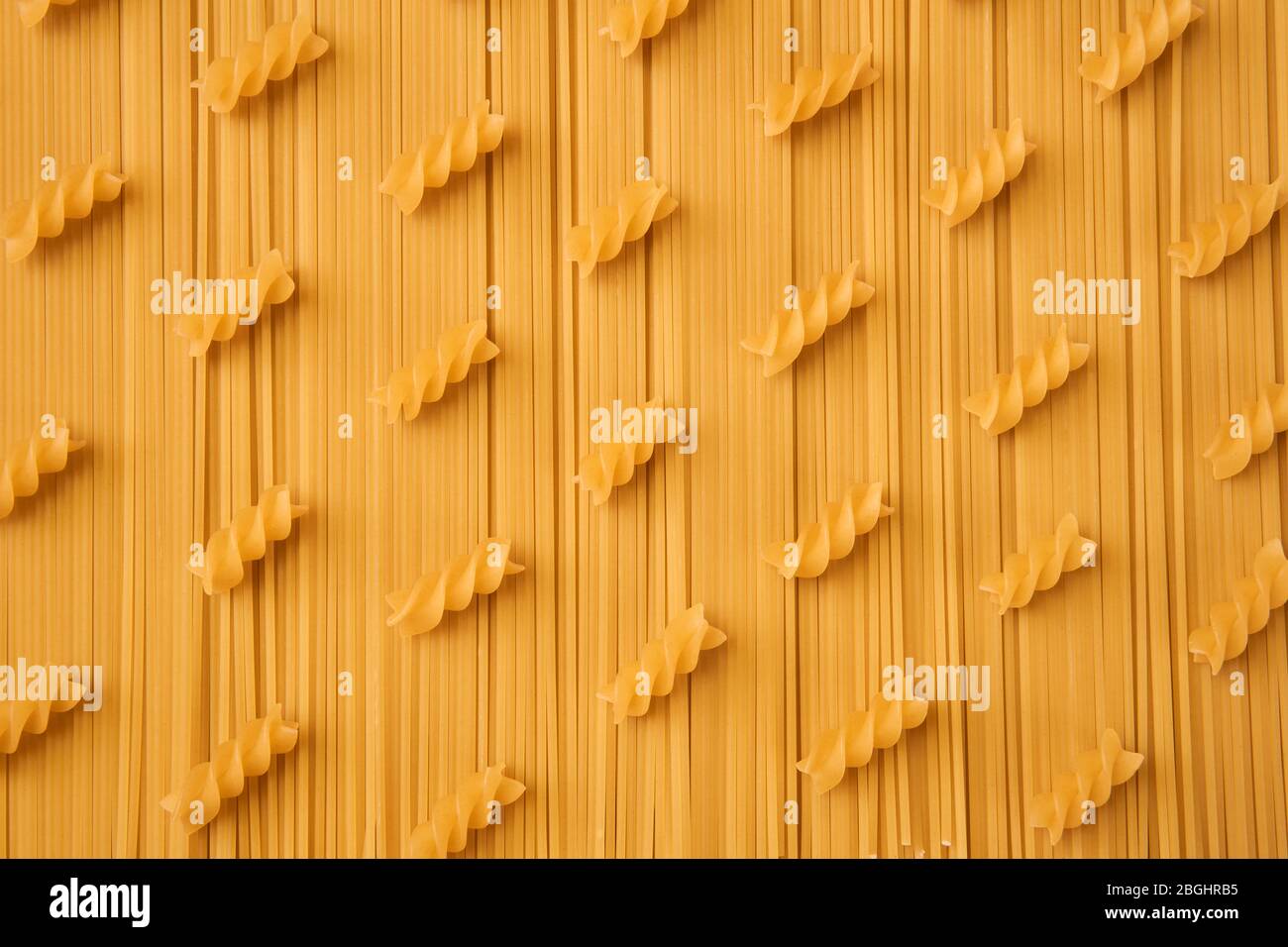 background of long and short-cut dry pasta, spaghetti and spiral Stock ...
