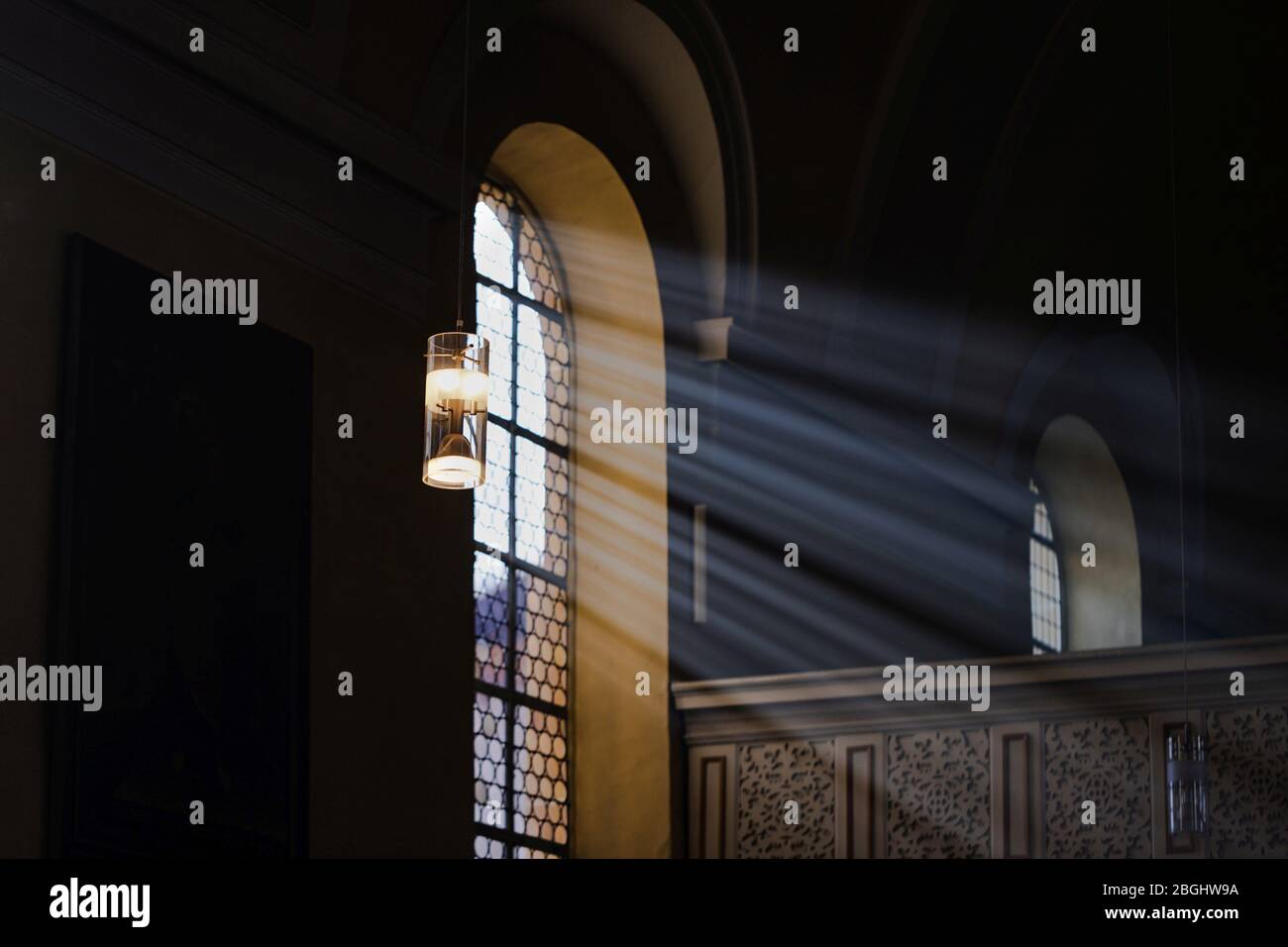 Light rays through the dark window. Toned photo Stock Photo - Alamy