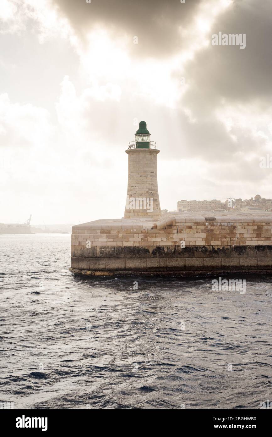 seascape image of the lighthouse at the end of the pier in Valletta ...