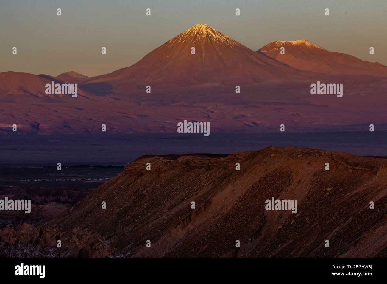 Female looking watching sun setting over the Andes Mountains from ...