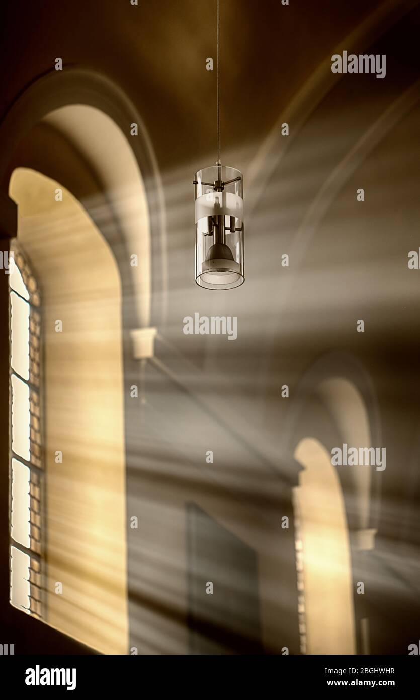 Light rays shines through the arched window. Toned photo Stock Photo ...