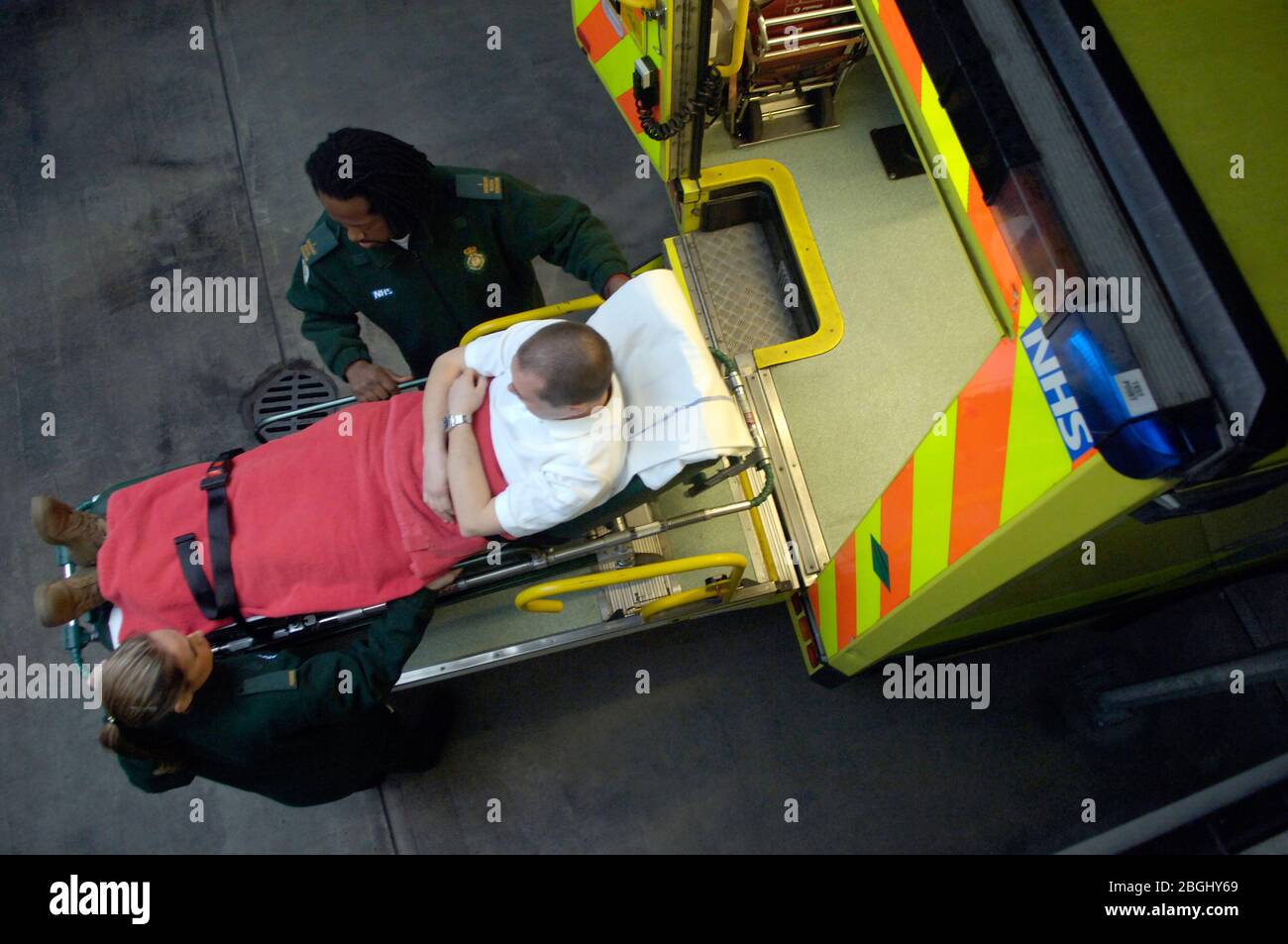 Paramedics load a patient into the back of an ambulance Stock Photo - Alamy