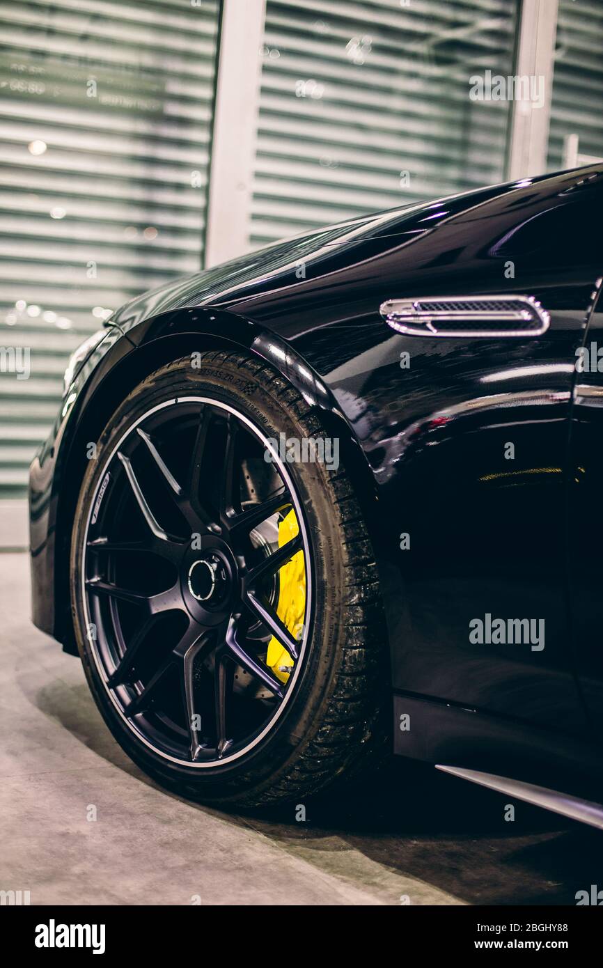 Black sport model car in front of the garage Stock Photo - Alamy