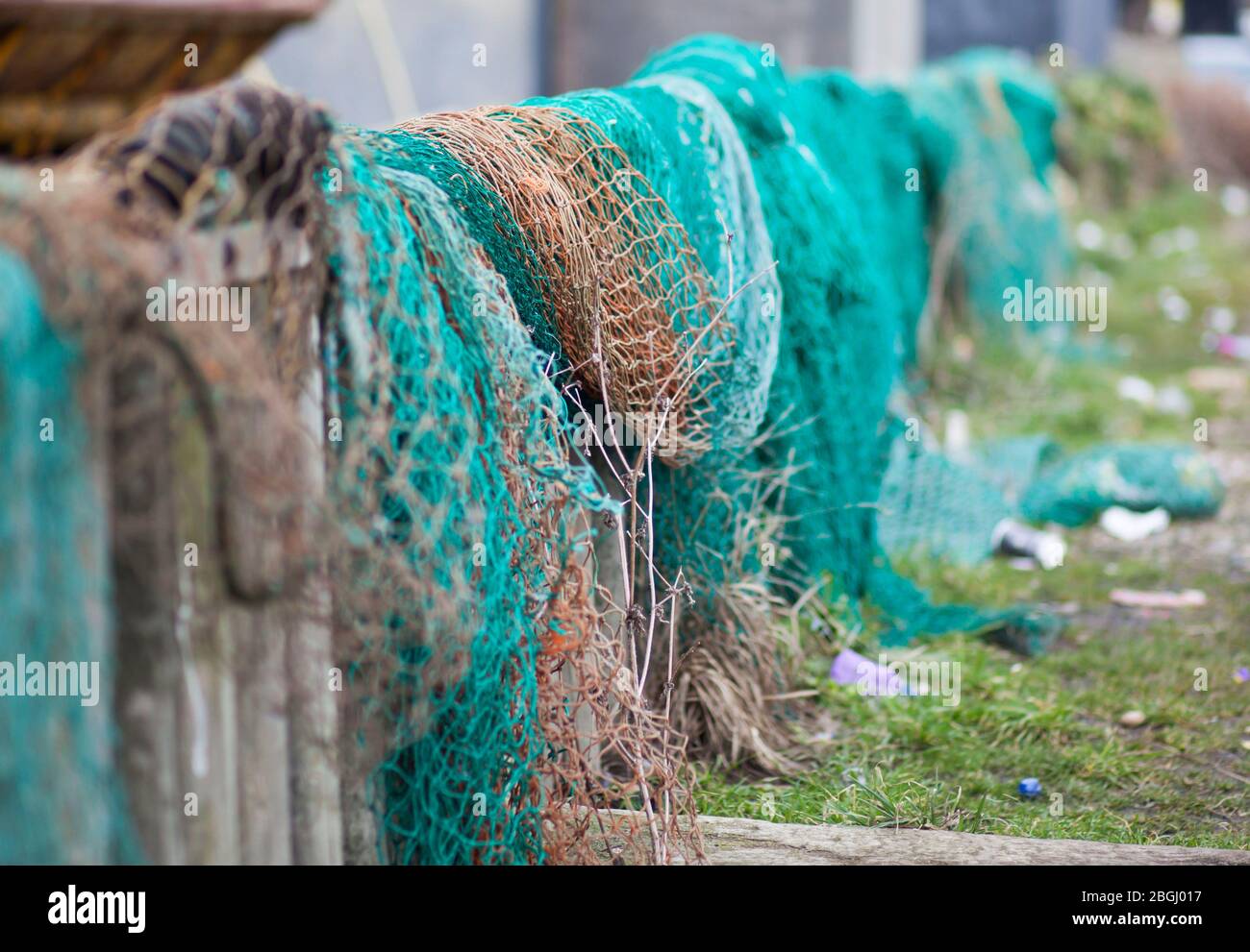 Fishermans nets hanging on fence Stock Photo - Alamy