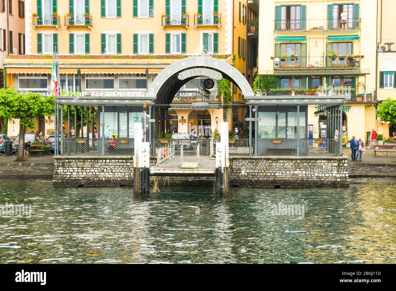 BELLAGIO, LAKE COMO, ITALY - JUNE 2019: The lakefront and ferry landing ...