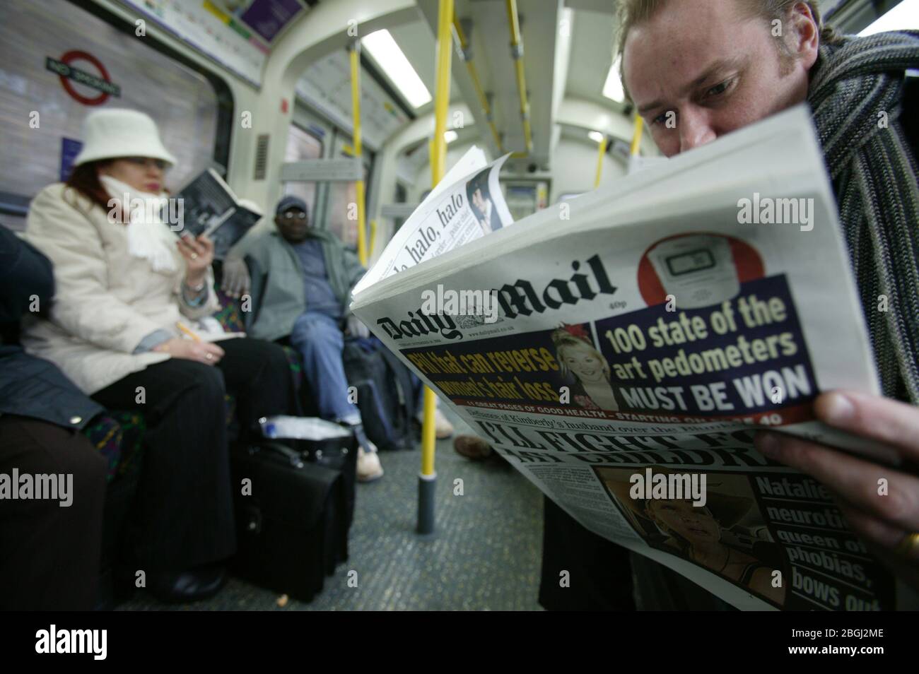 Picture shows: Person reading a Daily Mail newspaper Stock Photo - Alamy