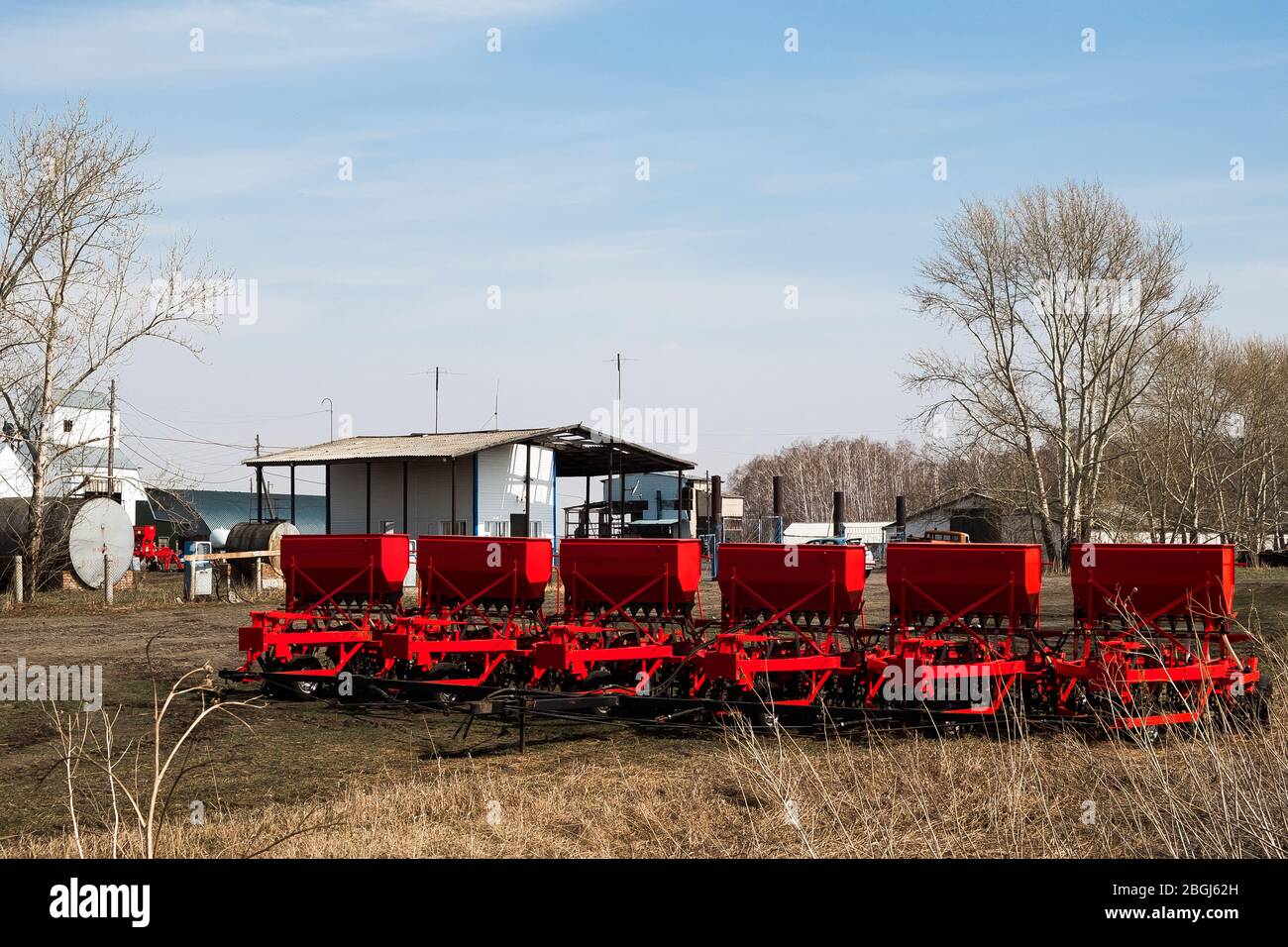 Red combine and plow, trailed sprayer with tank and liquid. Machinery ...