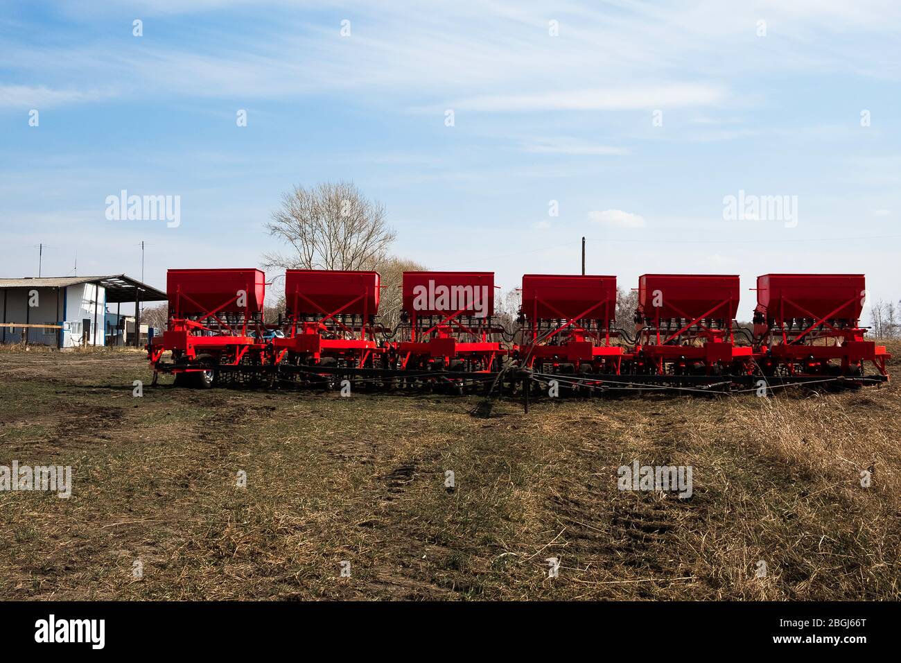 Red combine and plow, trailed sprayer with tank and liquid. Machinery ...