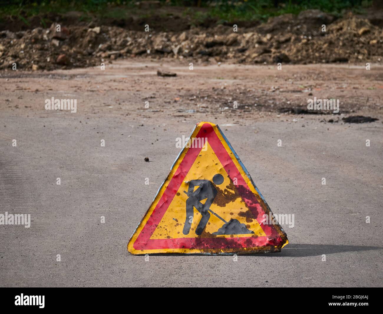Works ahead warning sign on a road. Old damaged road sing Stock Photo ...