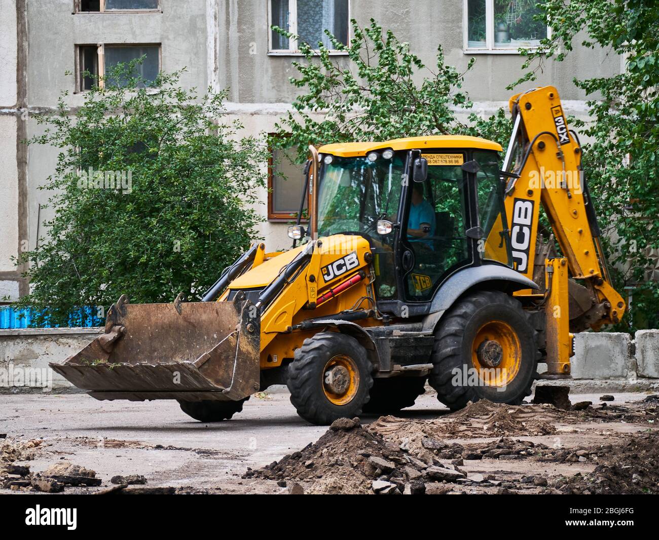 KHARKOV, UKRAINE - MARCH 2020, Hydraulic Excavator Removing Remains of ...
