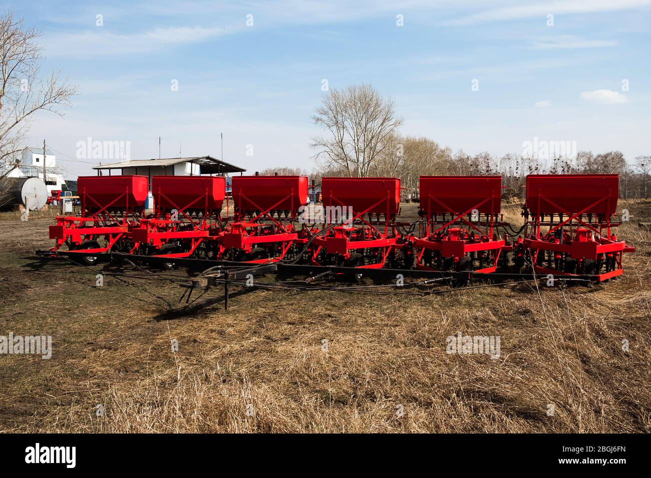 Red combine and plow, trailed sprayer with tank and liquid. Machinery ...