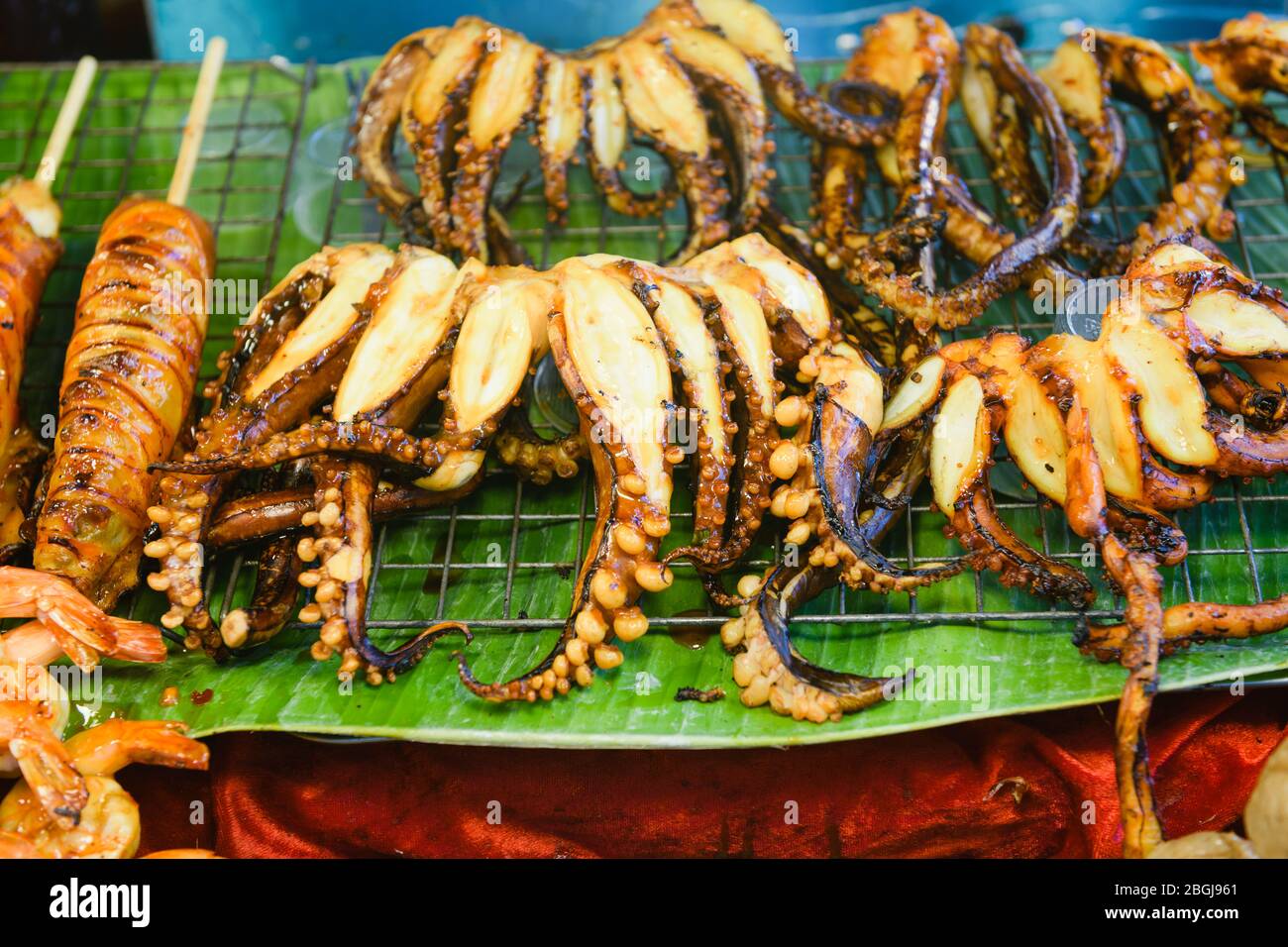 Close up roasted octopus at street market Stock Photo - Alamy