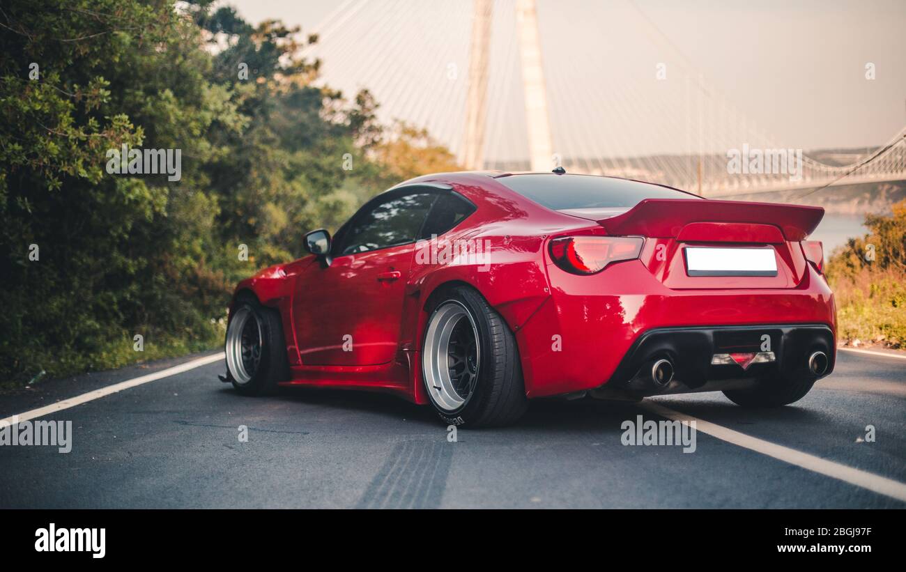 Modern red racing car commercial on the hill Stock Photo - Alamy