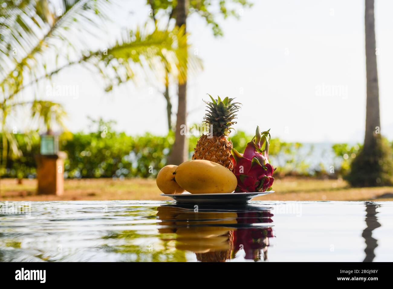 Plate of exotic fruits near swimming pool Stock Photo - Alamy