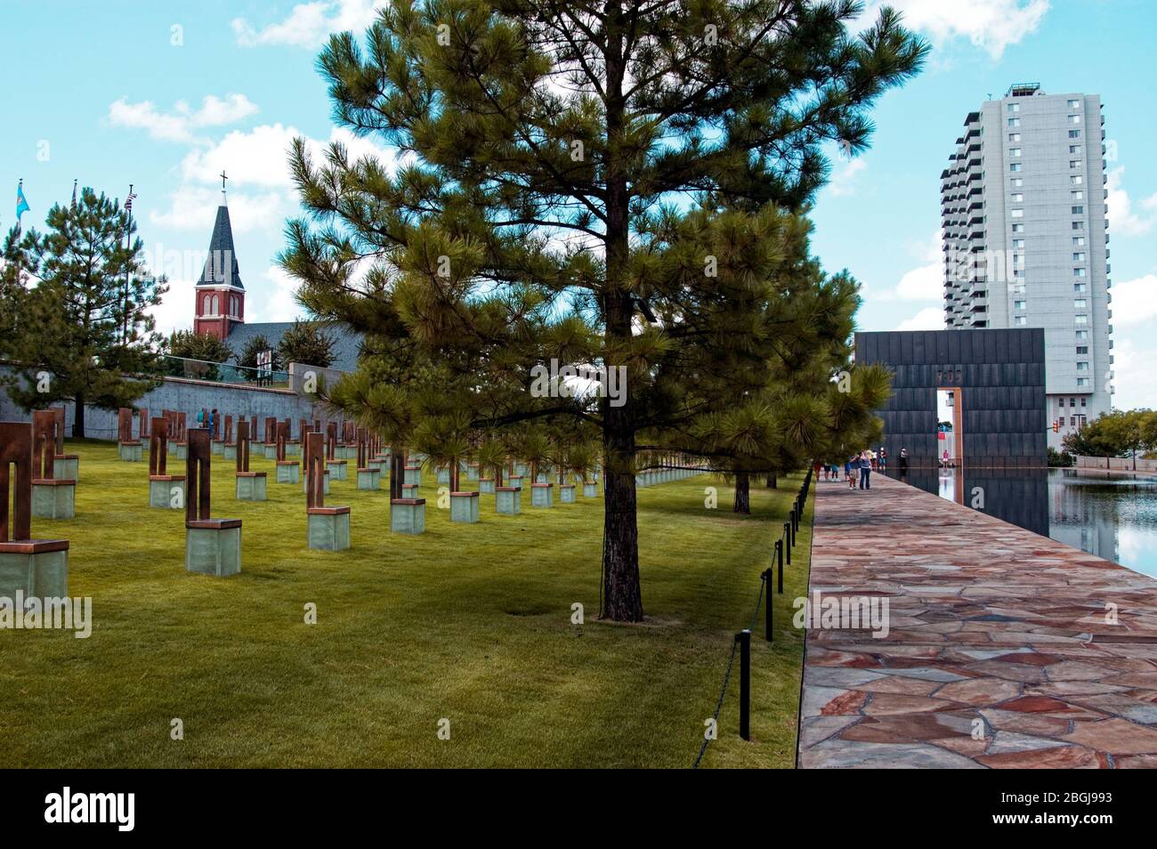 Visitors walk past markers for each of the victims of the bombing of ...