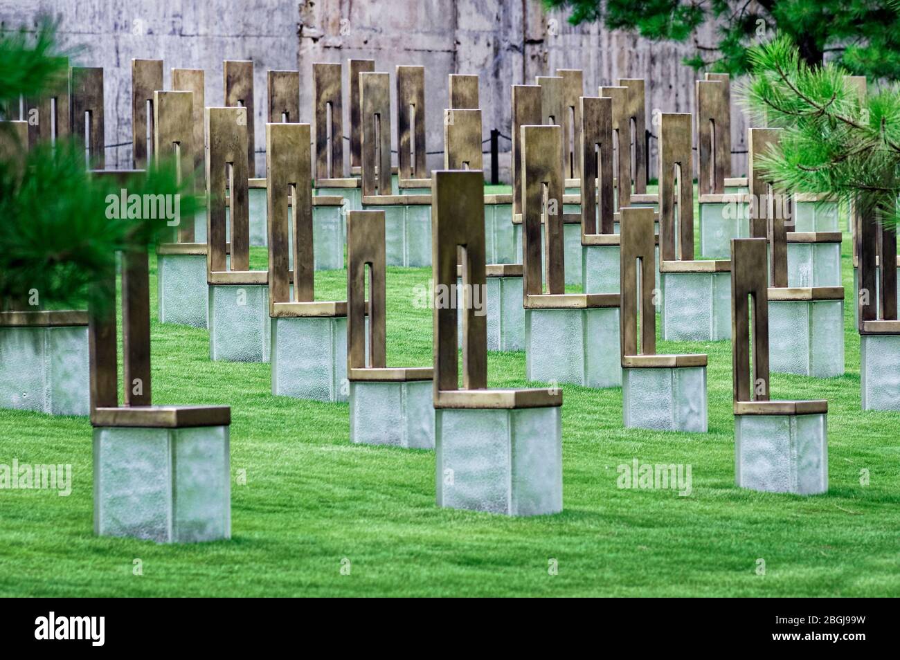 Visitors walk past markers for each of the victims of the bombing of ...