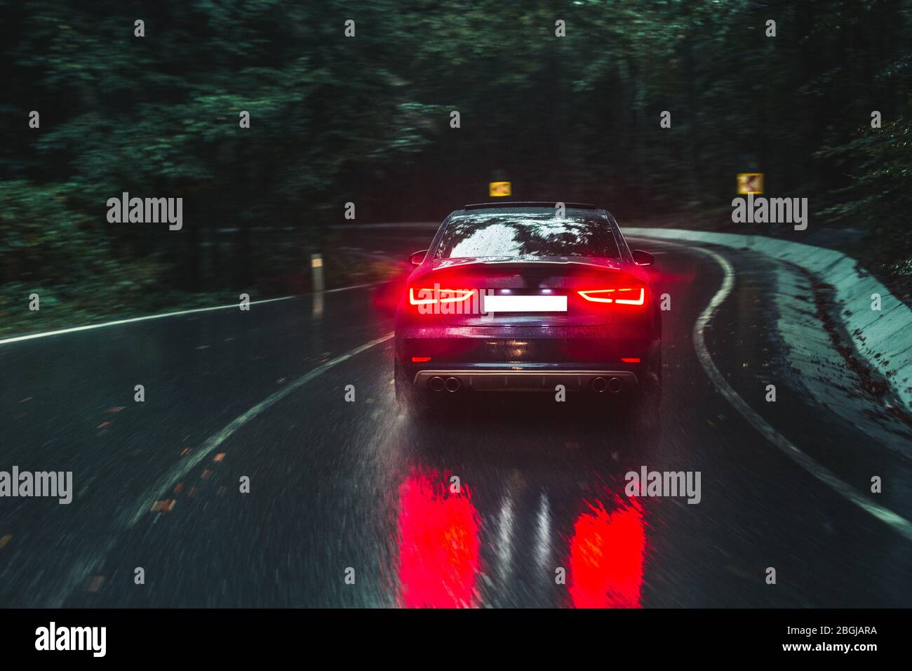 Driving silver car,red lights on in the dark forest in rain Stock Photo ...