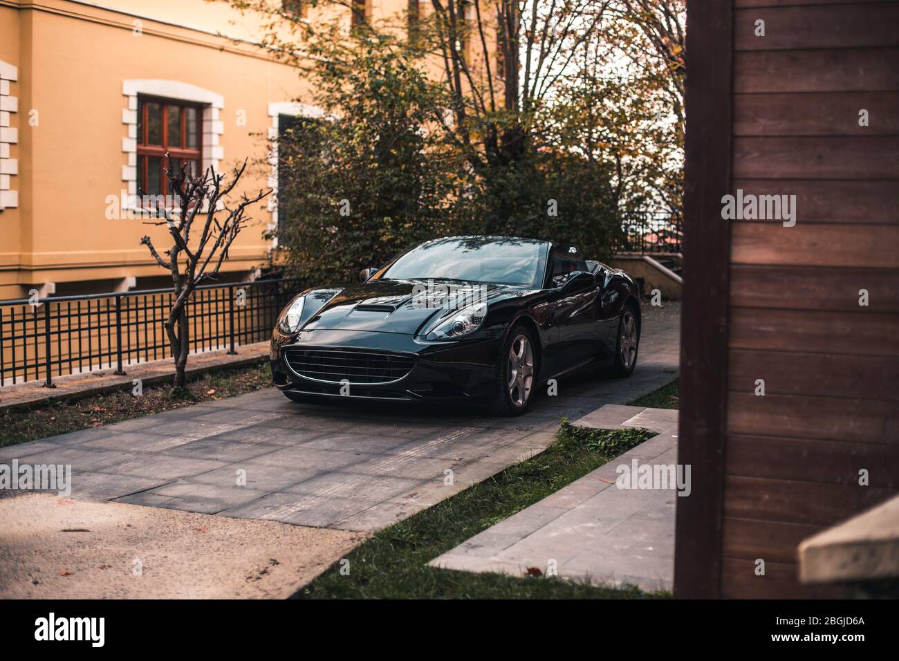 Black modern car in outdoor parking of a building Stock Photo - Alamy