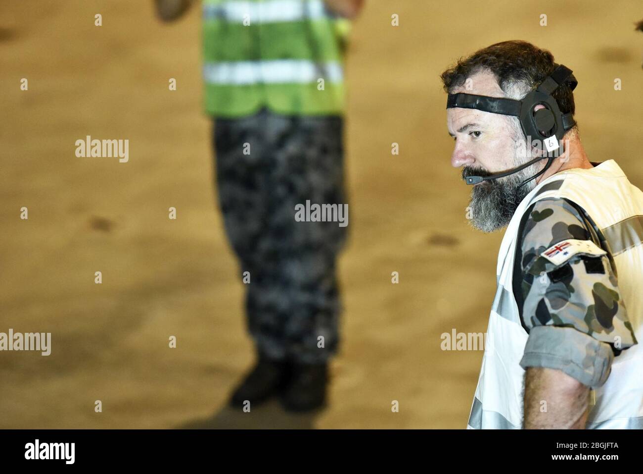 HMAS Canberra crew member supervising landing craft being loaded Stock ...