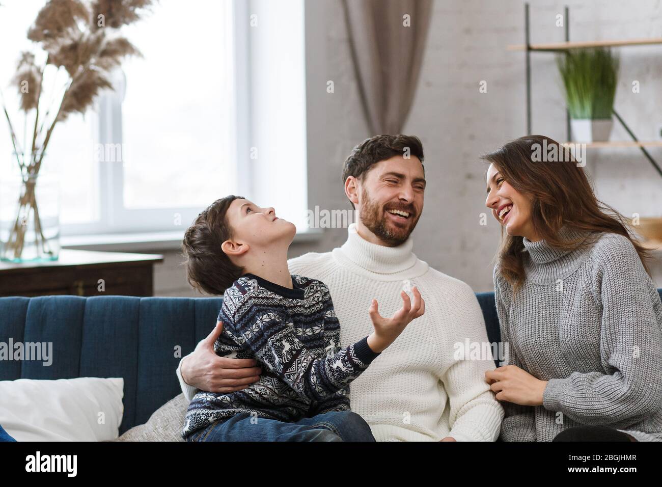Portrait of smiling father, mother and son. Happy family spending time ...