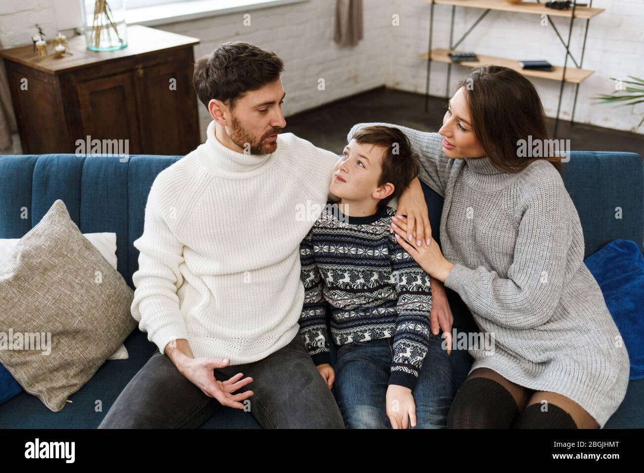 Portrait of smiling father, mother and son. Happy family spending time ...