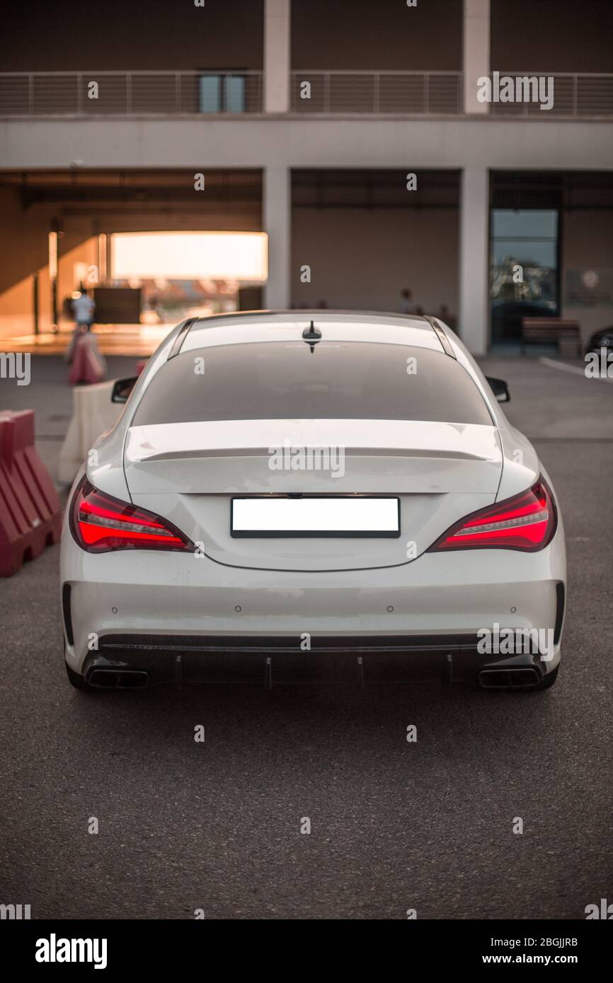 White sport sedan car in front of a business building, back view Stock ...