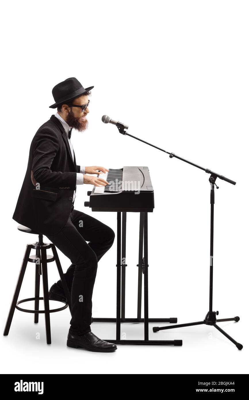 Solo musician playing keyboard and singing on a microphone isolated on ...