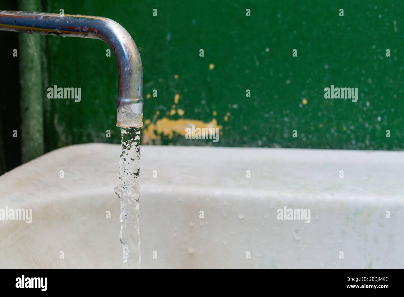 close-up view of old stained water tap with selective focus and ...