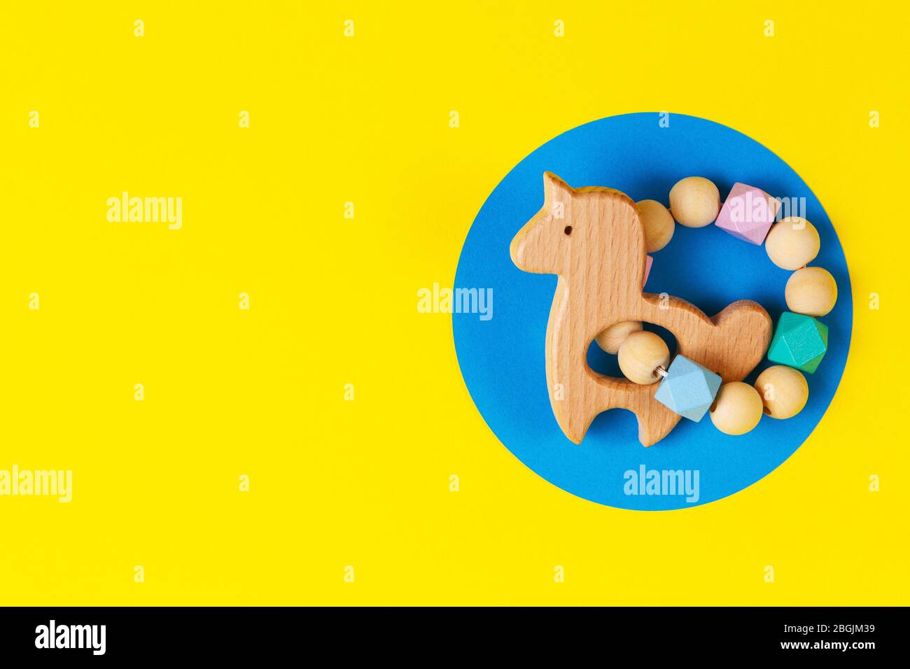 Baby kid educational natural eco zero waste wooden rattle toy on yellow ...