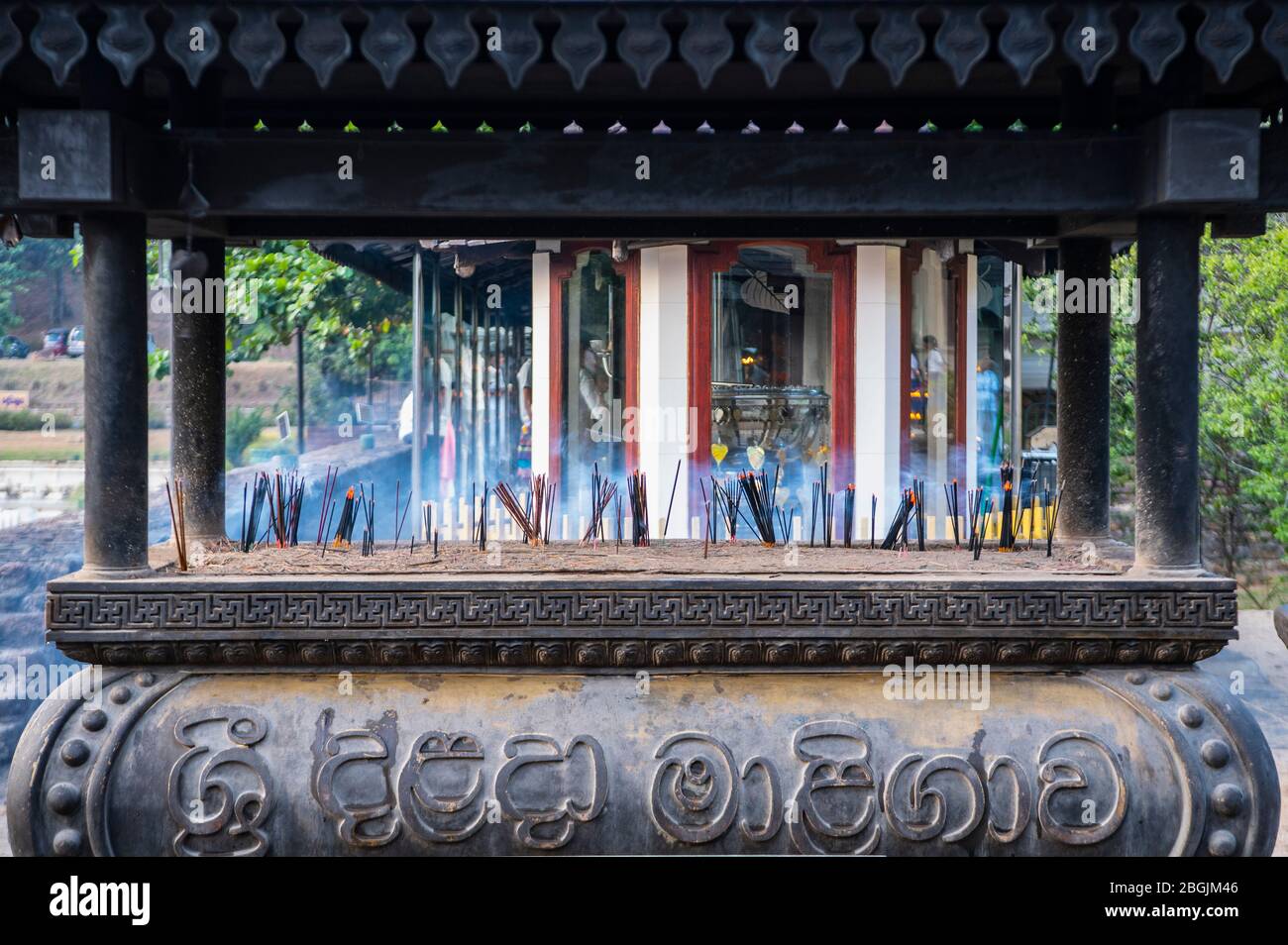 burning incense at at the shrine of the holy tooth relic in Kandy Stock ...