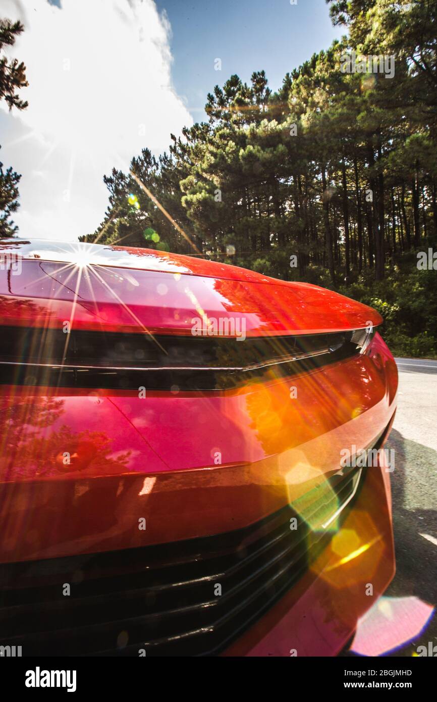 Red sport car bumper under the sunlights Stock Photo - Alamy