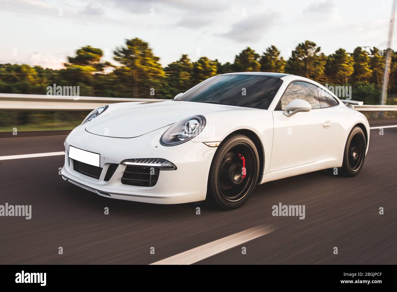 White sport sedan landscape driving on the highway Stock Photo - Alamy